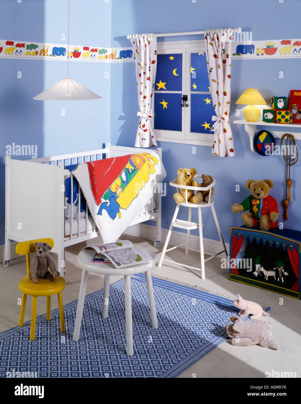 White cot and chairs in blue nursery with frieze border Stock Photo - Alamy