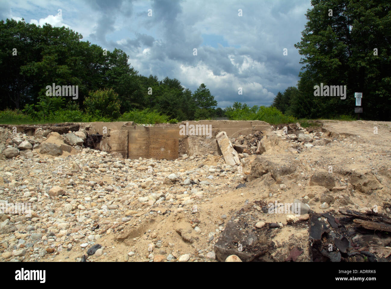 A section of washed out road from water over flowing a small pond Storm ...