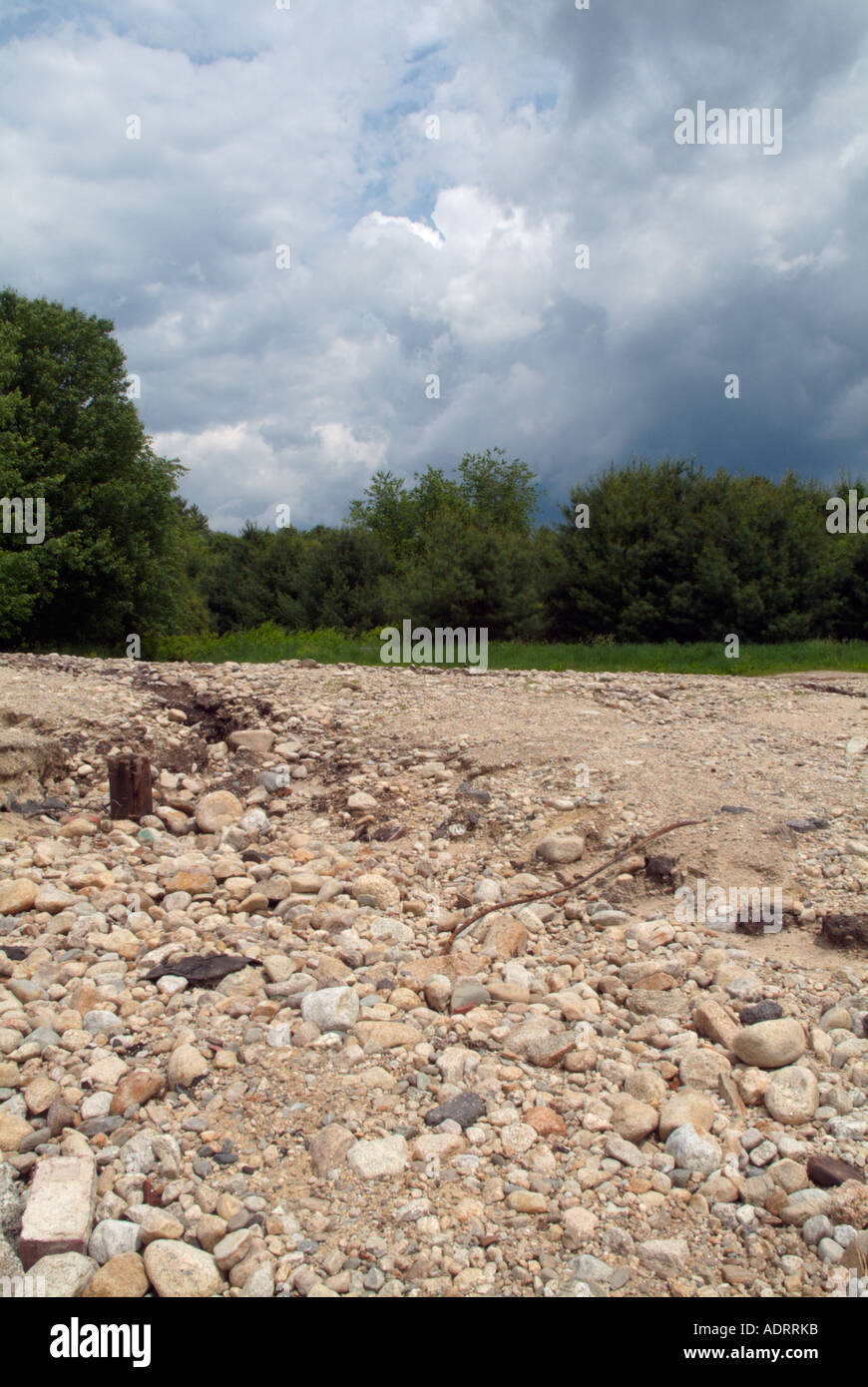 A section of washed out road from water over flowing a small pond Storm ...