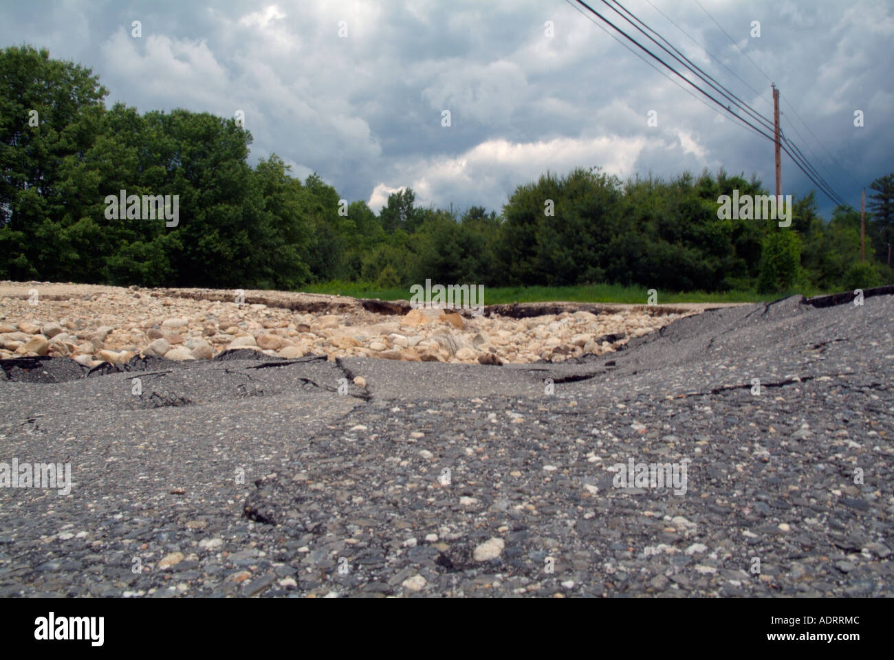 A section of washed out road from water over flowing a small pond Storm ...