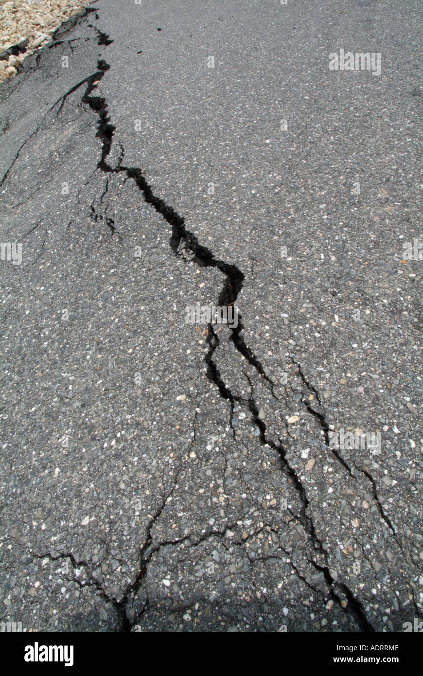 A section of washed out road from water over flowing a small pond Stock ...