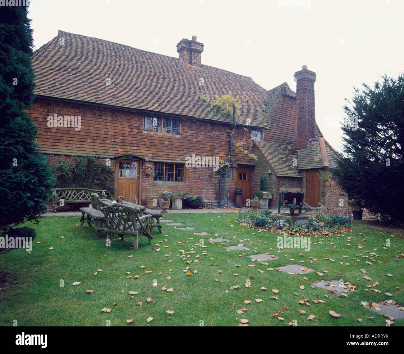 Lawn with paved path to traditional old brick country house Stock Photo ...