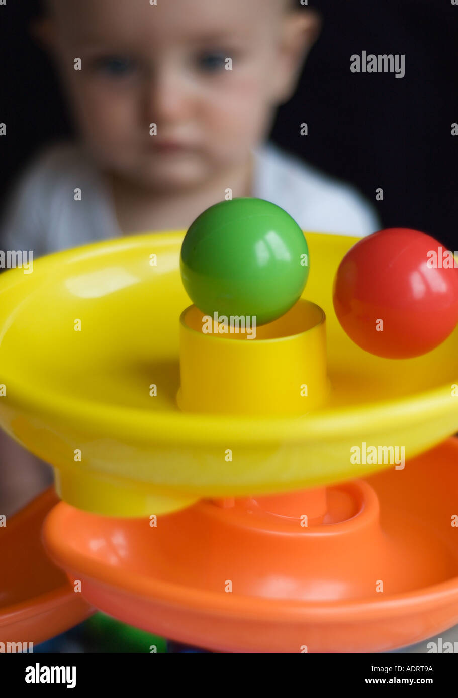 Nine month old baby boy watching his toy Stock Photo - Alamy