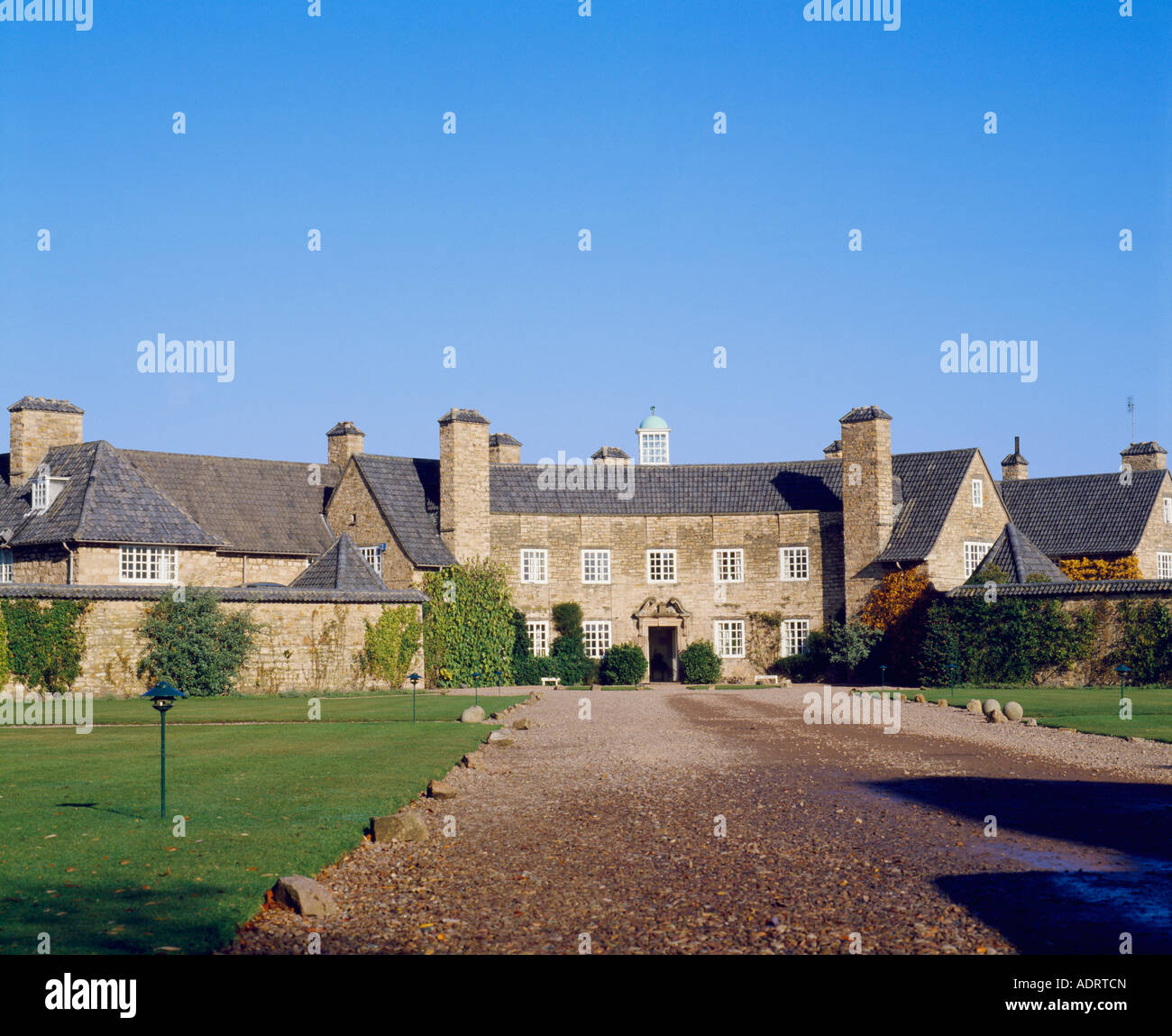 Drive leading to walled Georgian manor house Stock Photo - Alamy