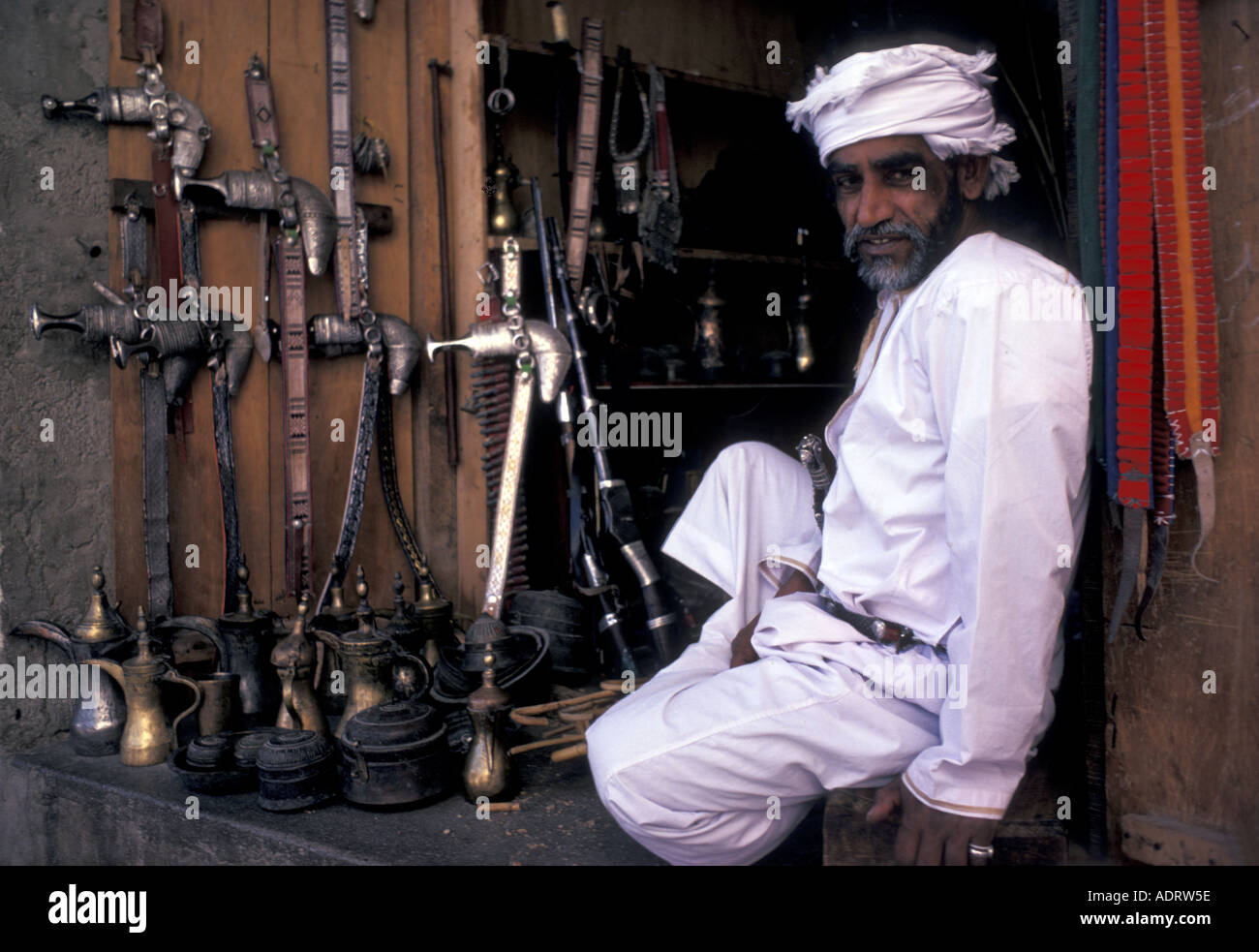 A trader selling antique weapons in Muttrah Souq, Sultanate of Oman ...