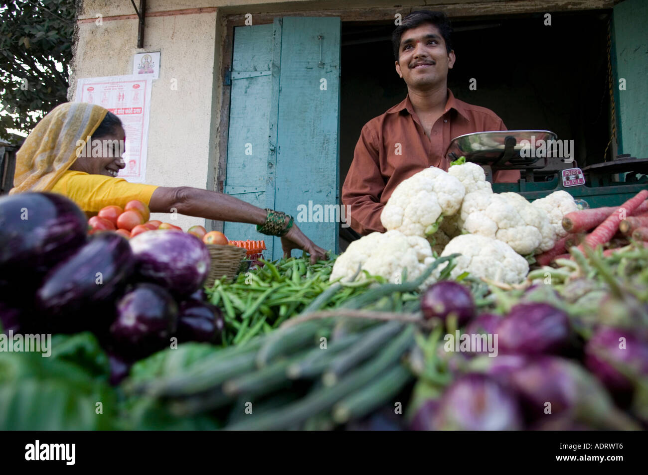 A fruit and vegetable market stall trader in a shanty town Poona Delhi ...