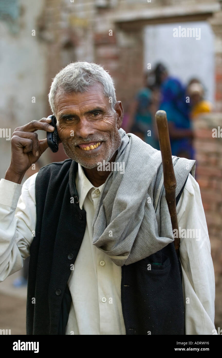 Man in a poor farming community near Agra using a mobile phone India ...
