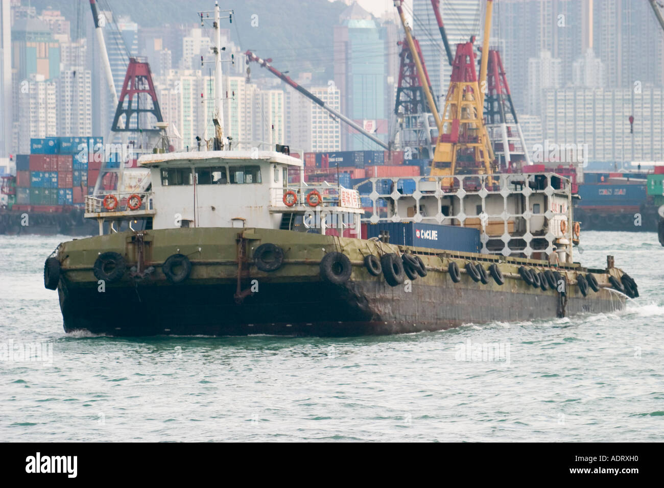 Self powered shipping container transfer barge entering Kowloon Typhoon ...