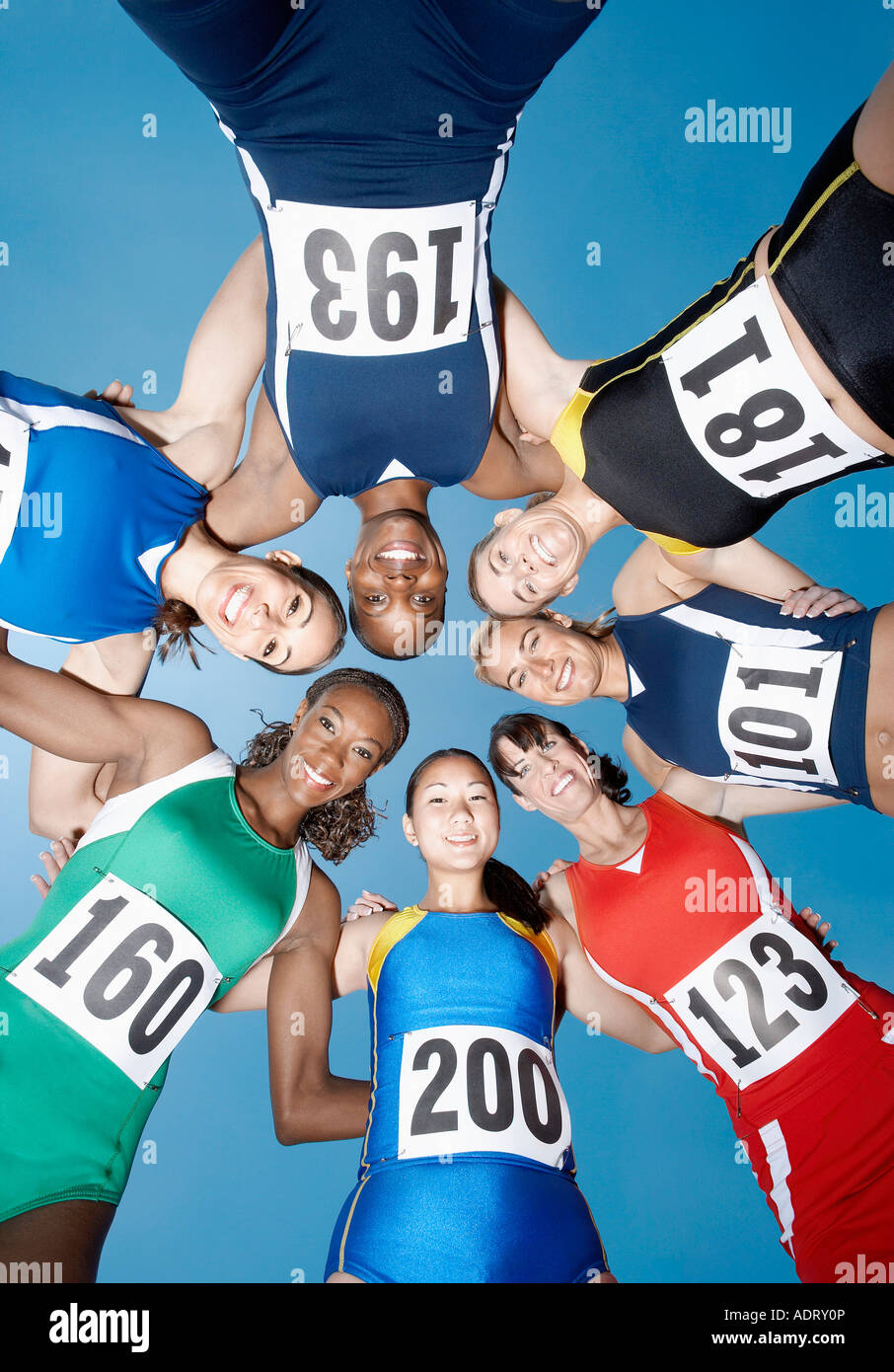 Track and field athletics smiling in a circle, view from below Stock ...