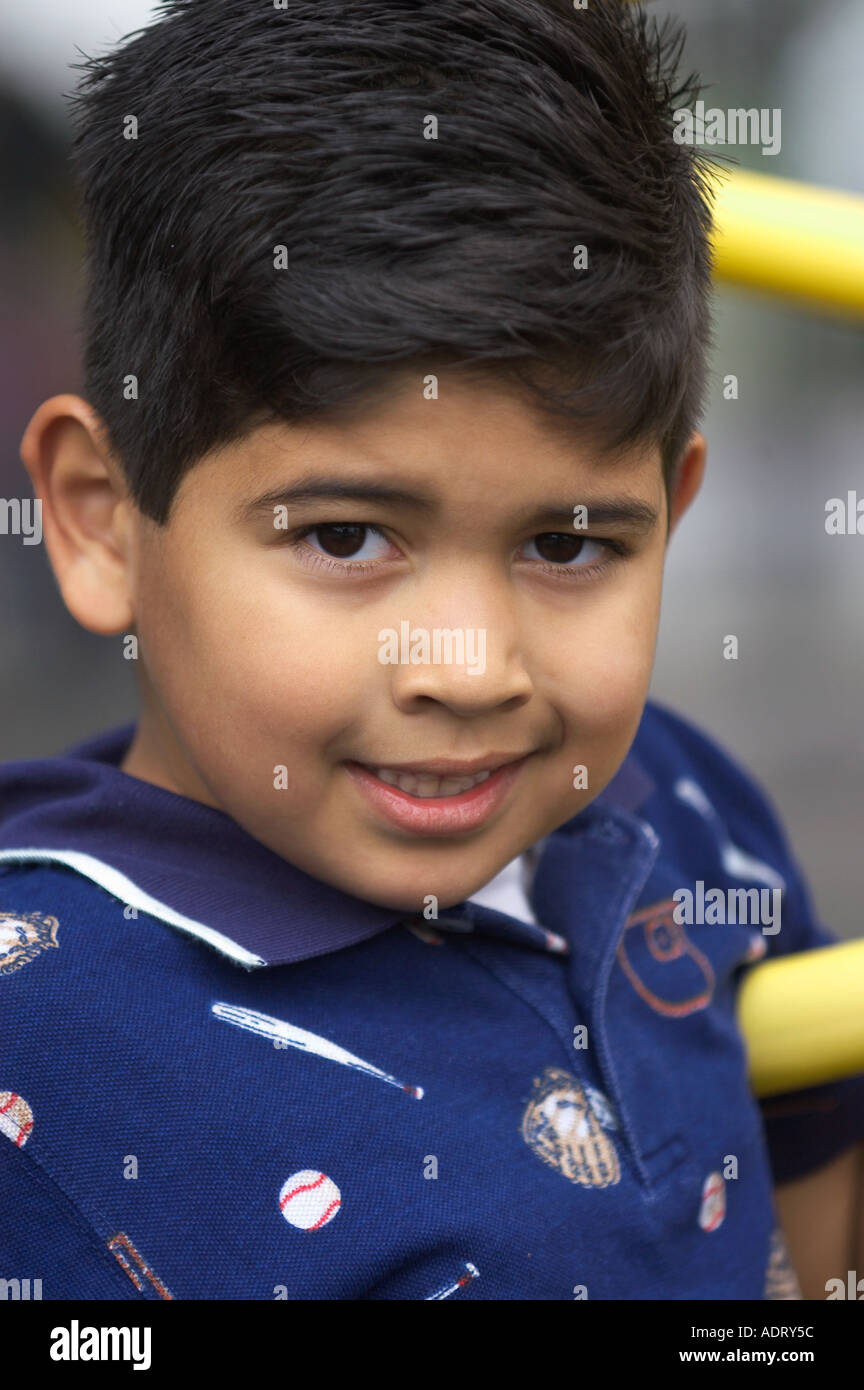 Hispanic boy on playground bars Stock Photo - Alamy