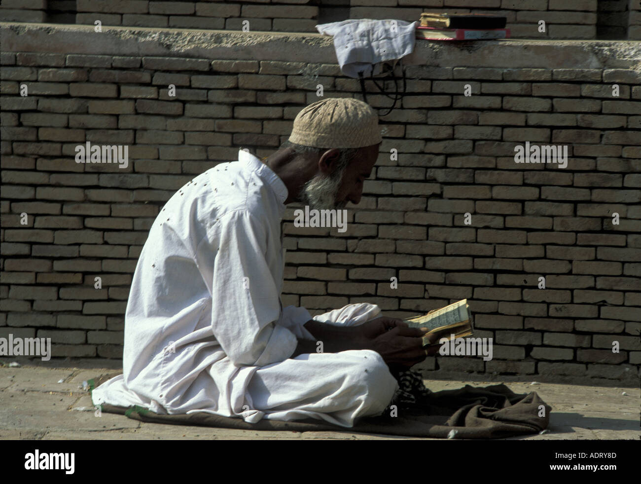 Old Muslim man reading the holy Quran throughout the night of Lailat al ...