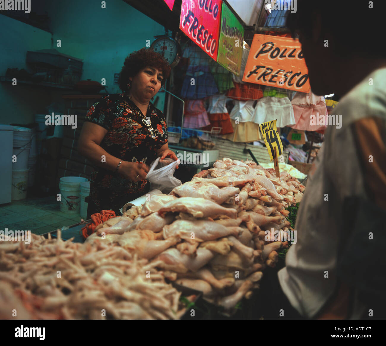 A woman sells fresh chicken in a popular downtown market in Torreon ...
