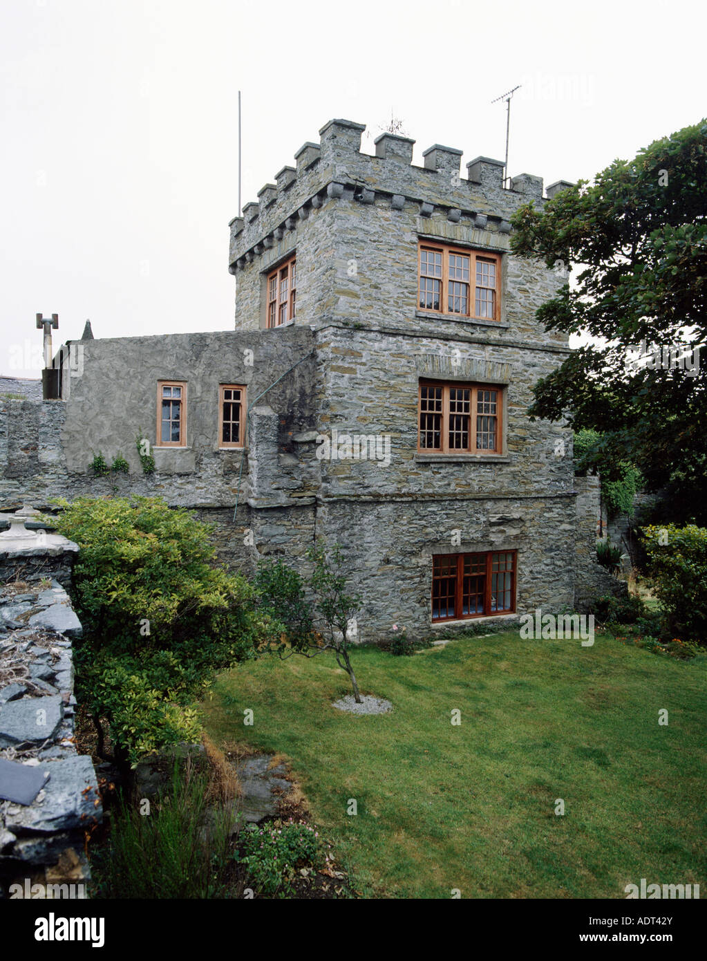 Castellated stone house with traditional replacement windows Stock ...