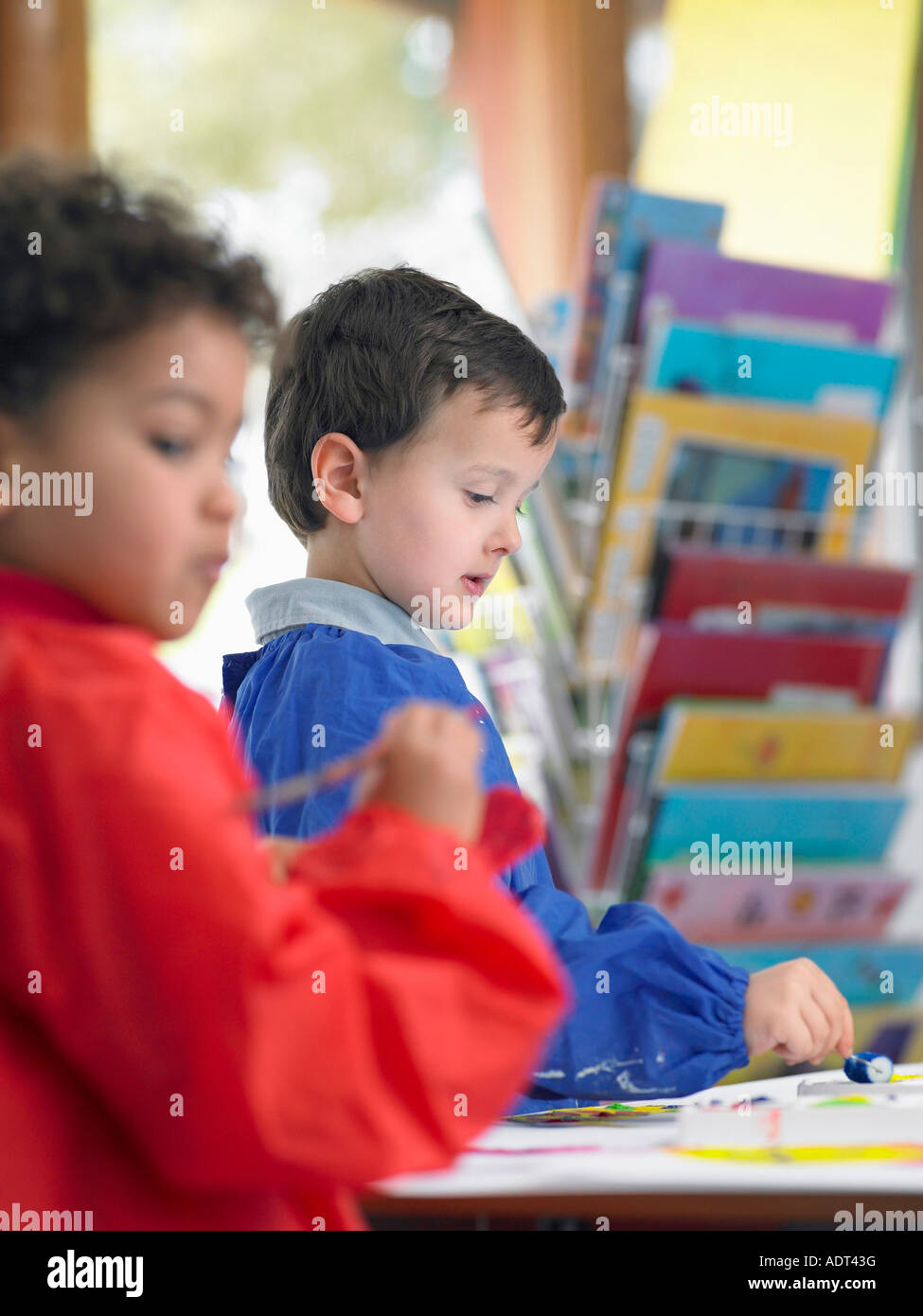 Elementary students painting in art class Stock Photo - Alamy