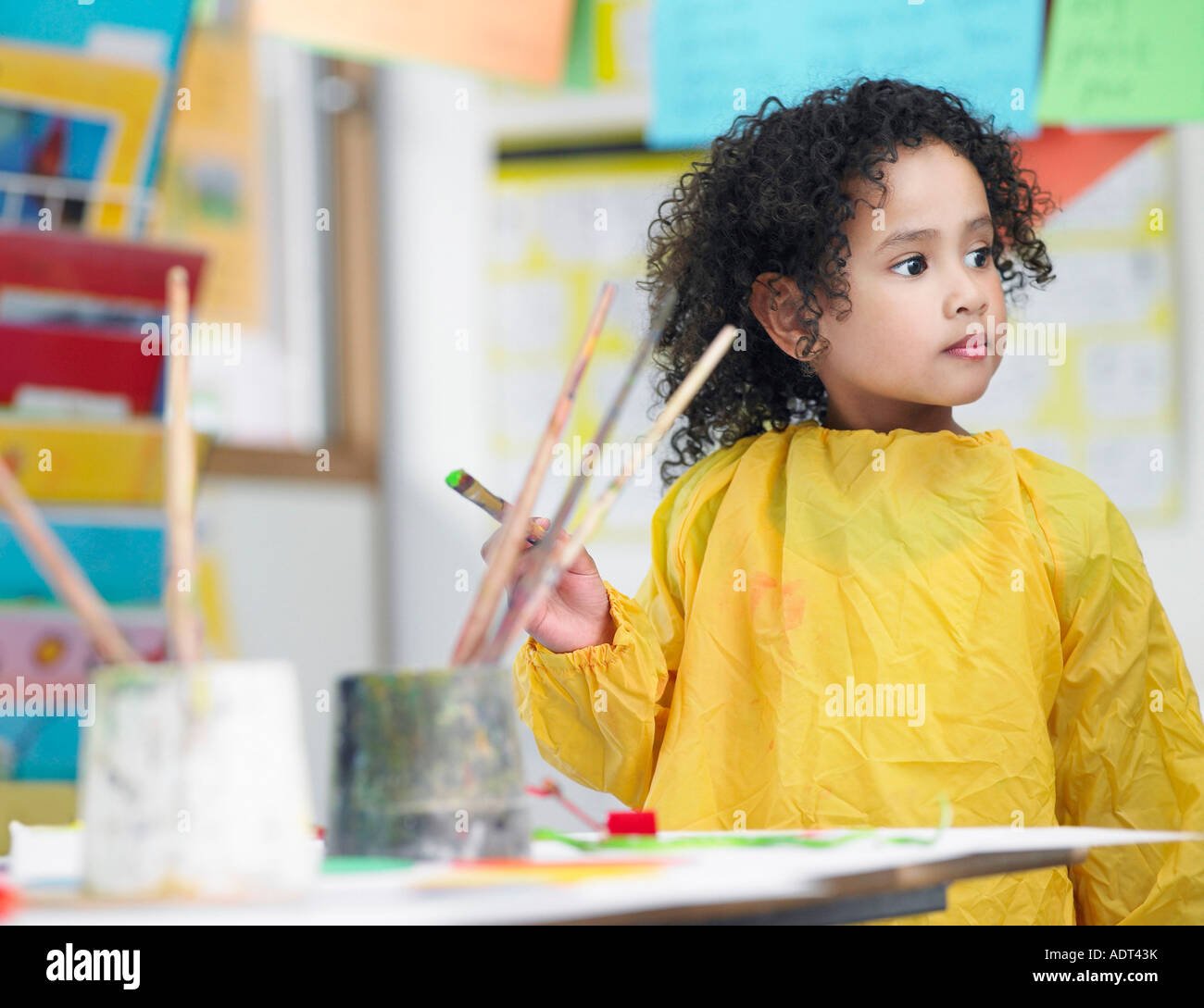 Girl painting in art class Stock Photo - Alamy