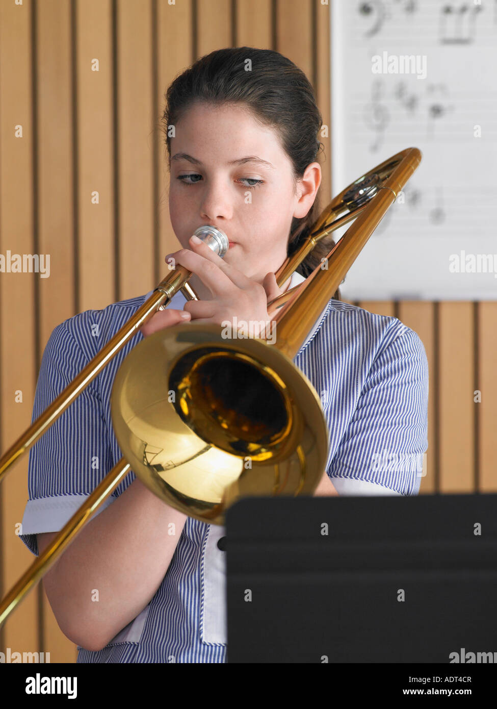 High school girl playing trombone in class, portrait Stock Photo - Alamy