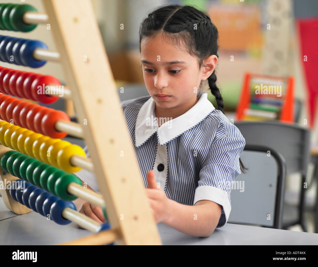 Schoolgirl using abacus in classroom Stock Photo - Alamy