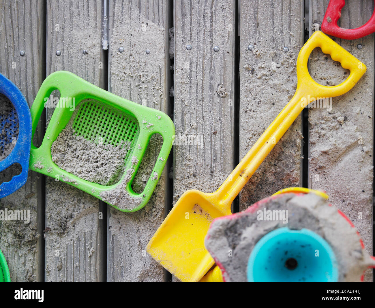 Sand pit toys lying on wooden deck, view from above Stock Photo - Alamy