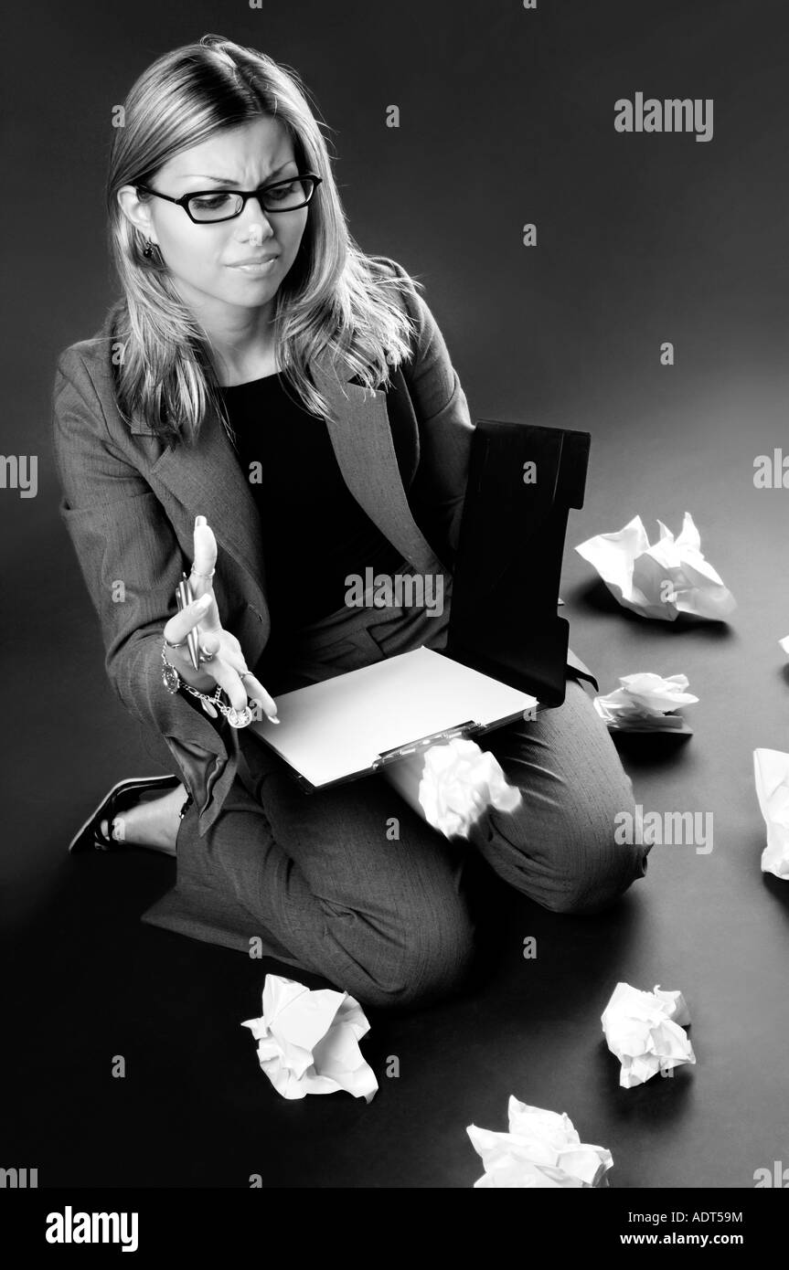 Businesswoman throwing crampled paper on the floor Stock Photo - Alamy