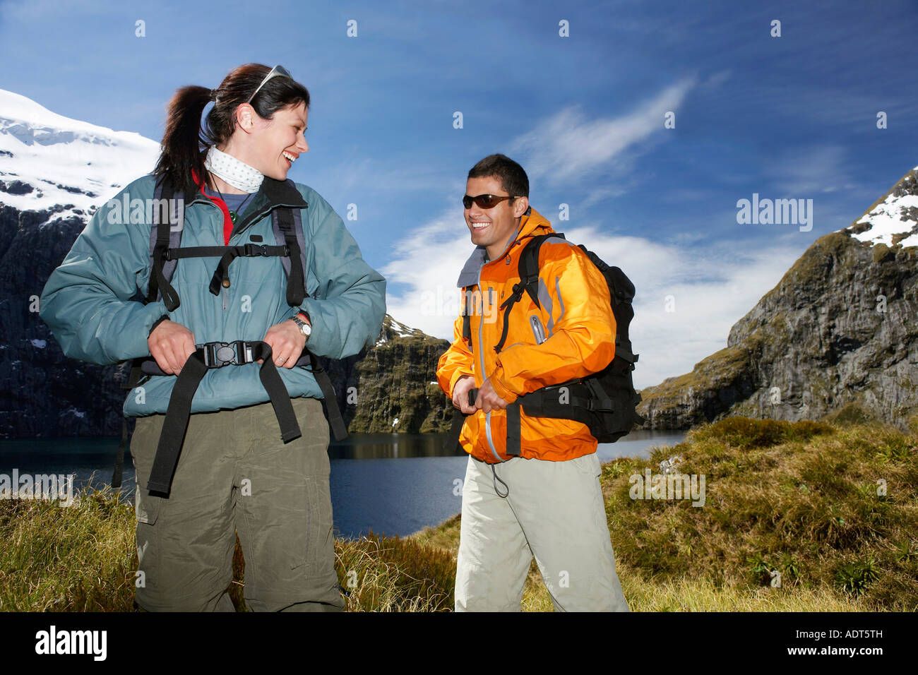 Two hikers smiling on mountain peak Stock Photo - Alamy