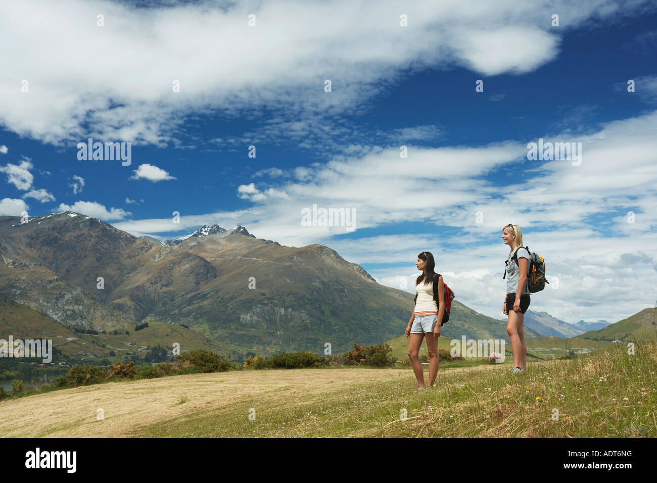 Two women hiking in hills near mountains Stock Photo - Alamy