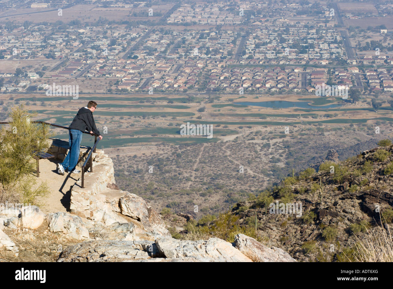 Teenage boy looking out at Phoenix suburbs from Dobbins Lookout at ...