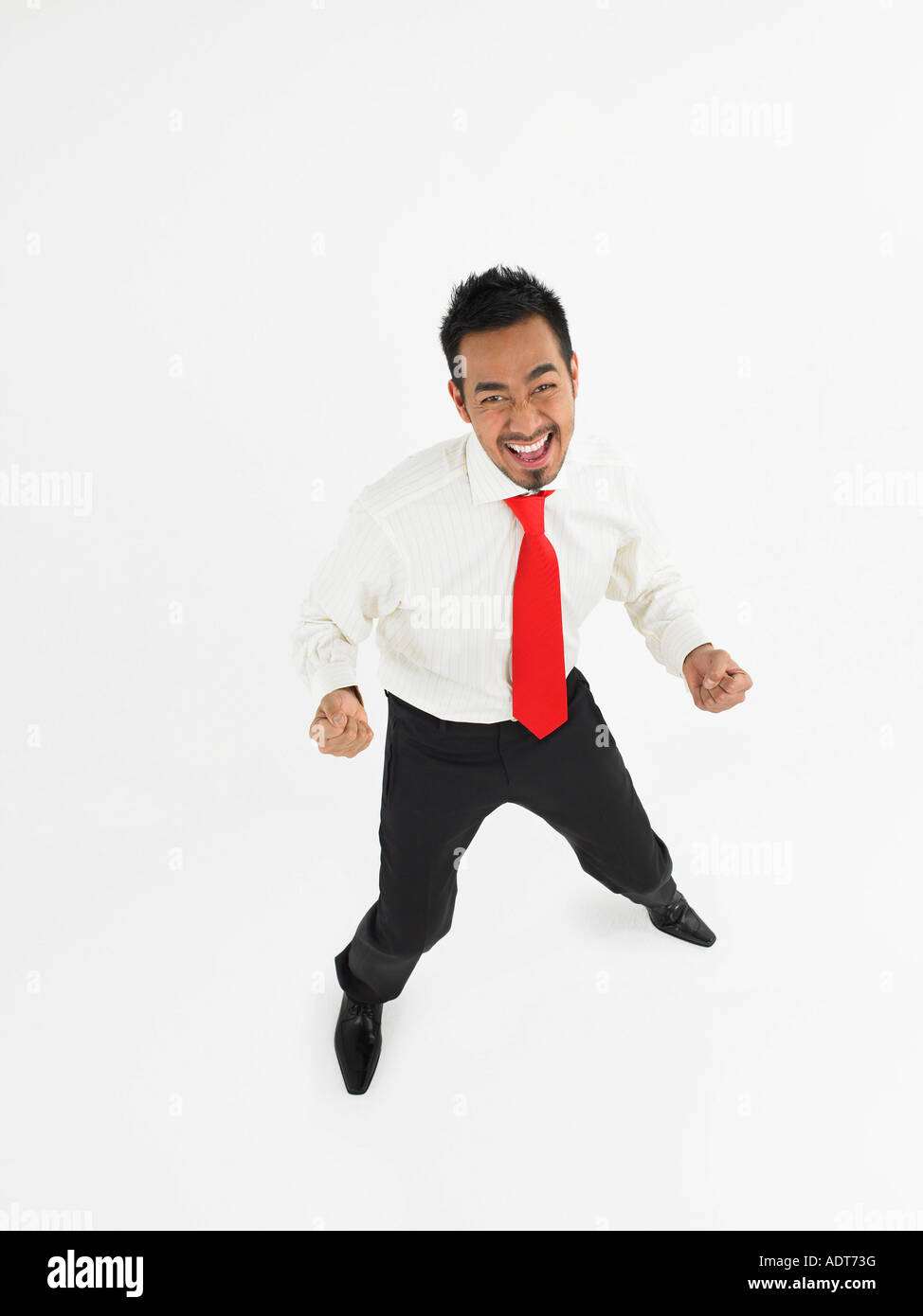 Man celebrating in studio, full length Stock Photo - Alamy