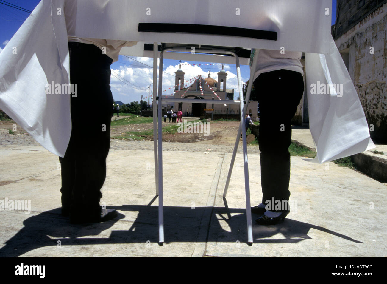 A man and a woman cast ballots in a portable voting booth during ...