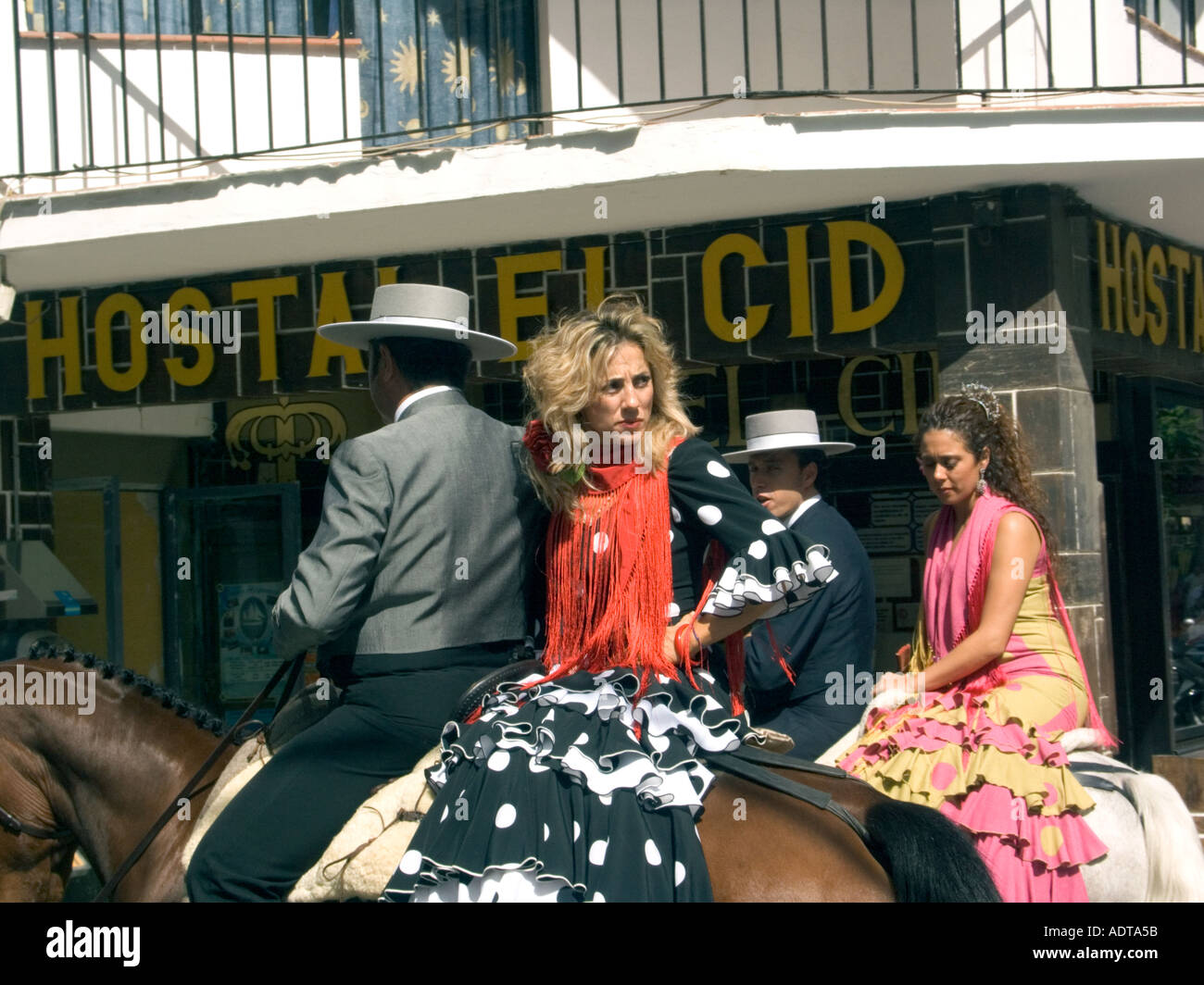Spanish People in Traditional Costumes riding in the street at the ...