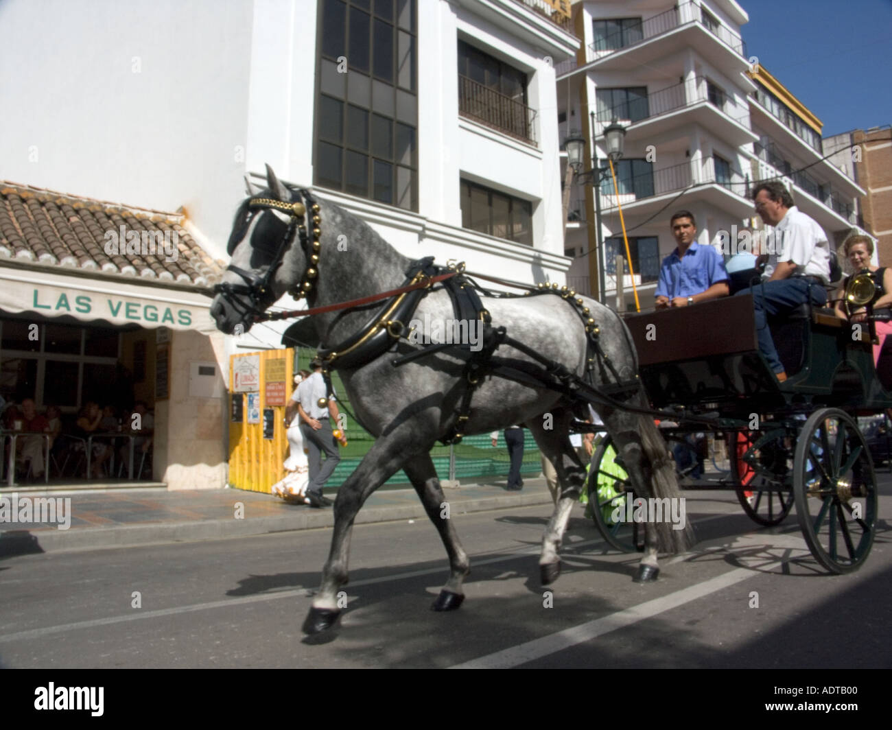 Spanish People riding in an open horse drawn carriage at the Fuengirola ...