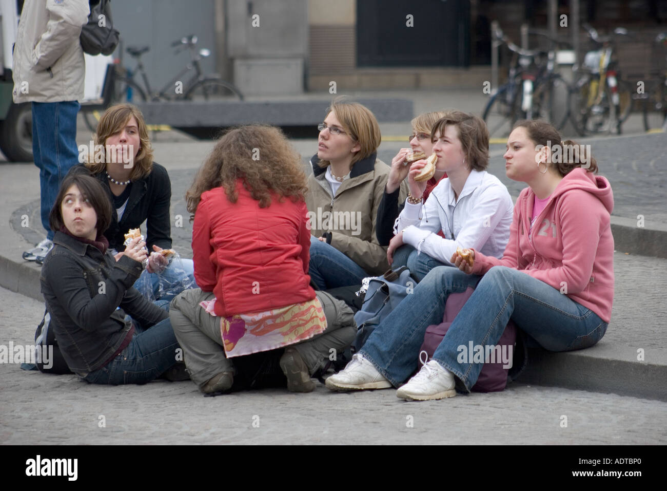 Group of young girls sitting in Dam Square Amsterdam Netherlands Stock ...
