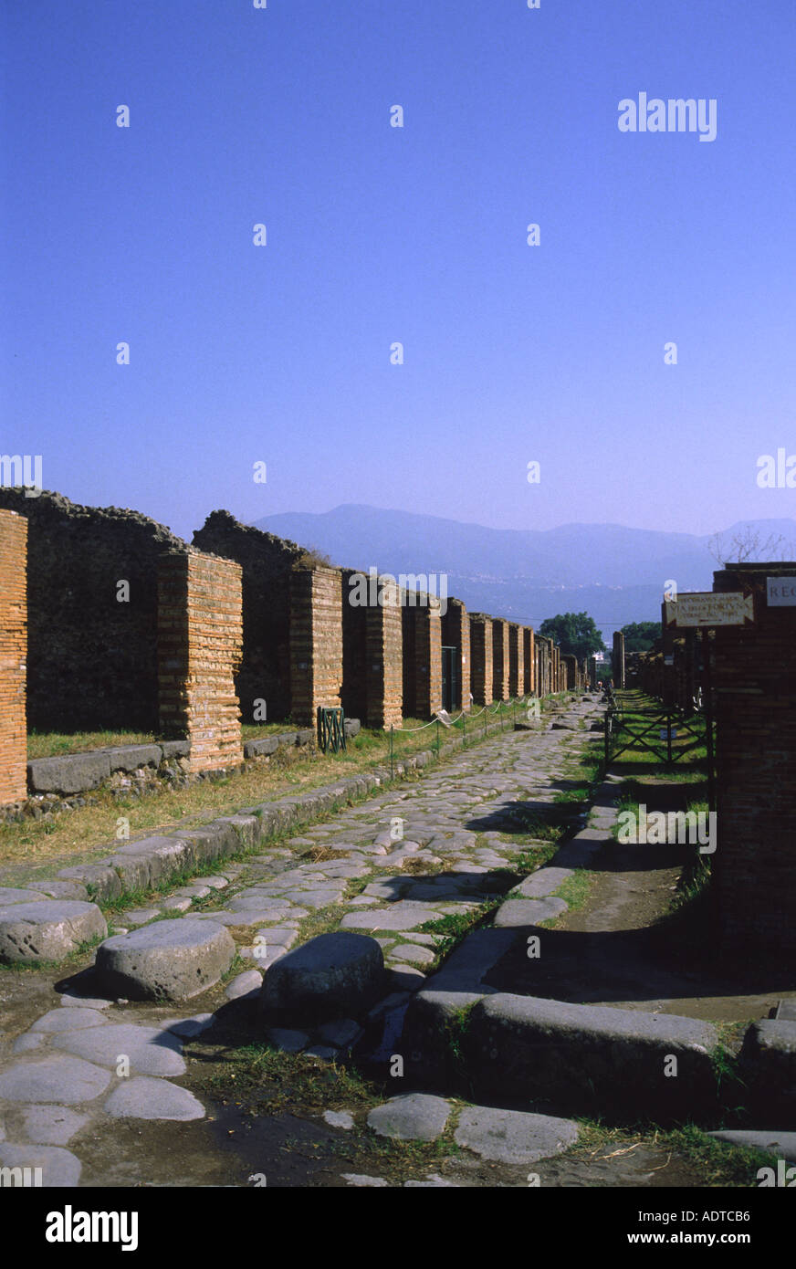 Main street of ancient Pompeii known as Decumanus Major at crossing ...