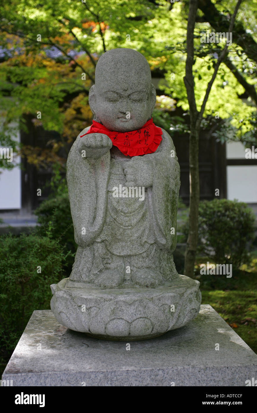 Traditional white stone statue of buddha at a temple in Kyoto Kansai ...