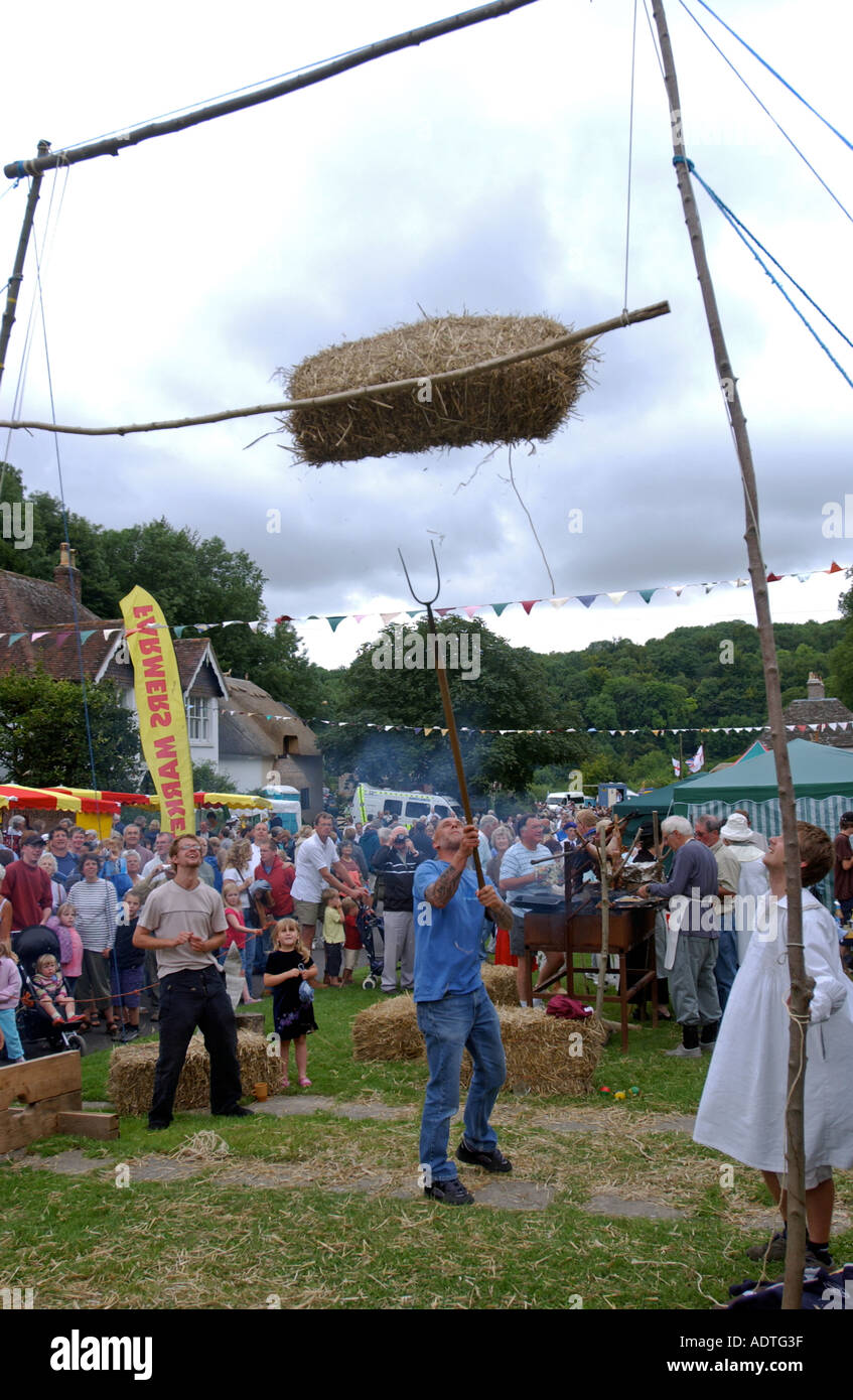 Throwing a haybale game at Milton Abbas village street fair in Dorset ...