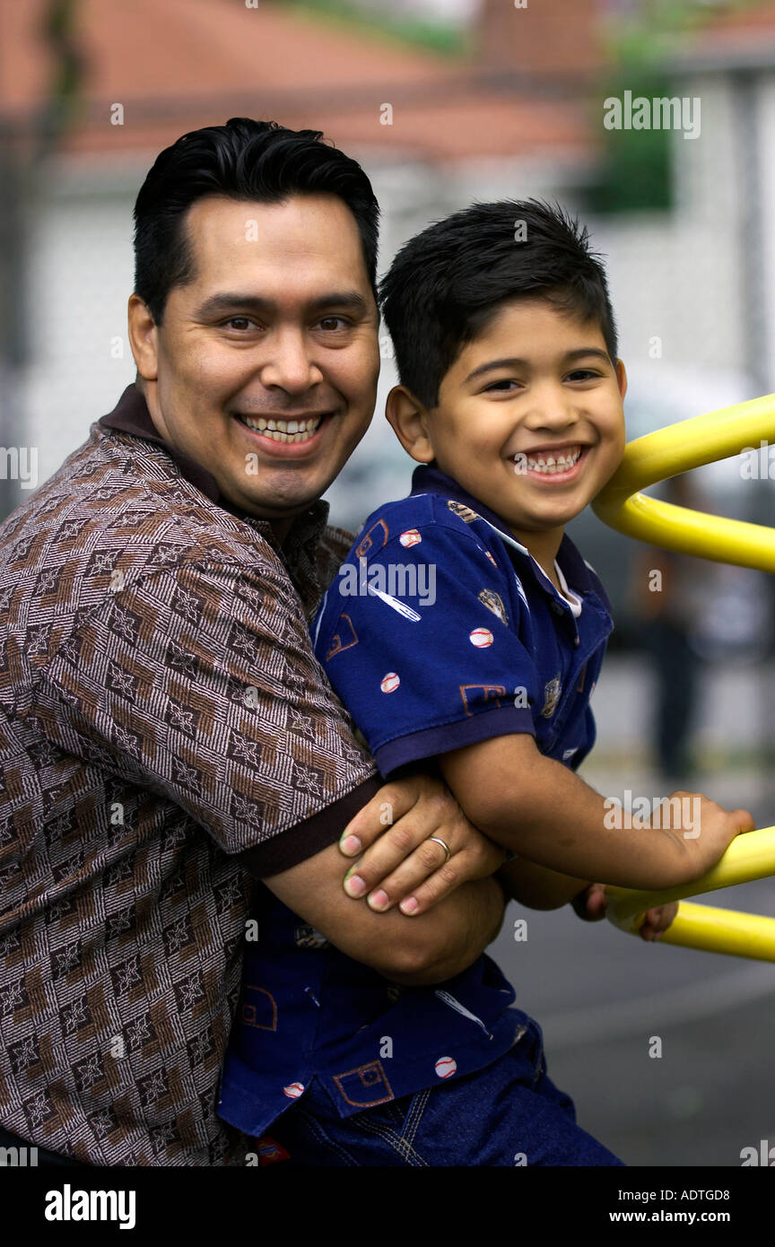 Hispanic father and son at playground Stock Photo - Alamy