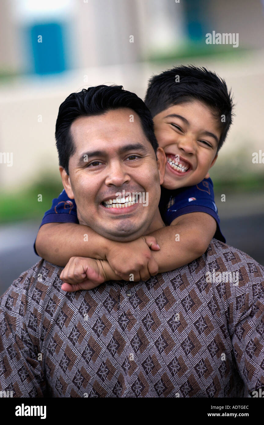 Hispanic boy hugging his father tightly Stock Photo - Alamy