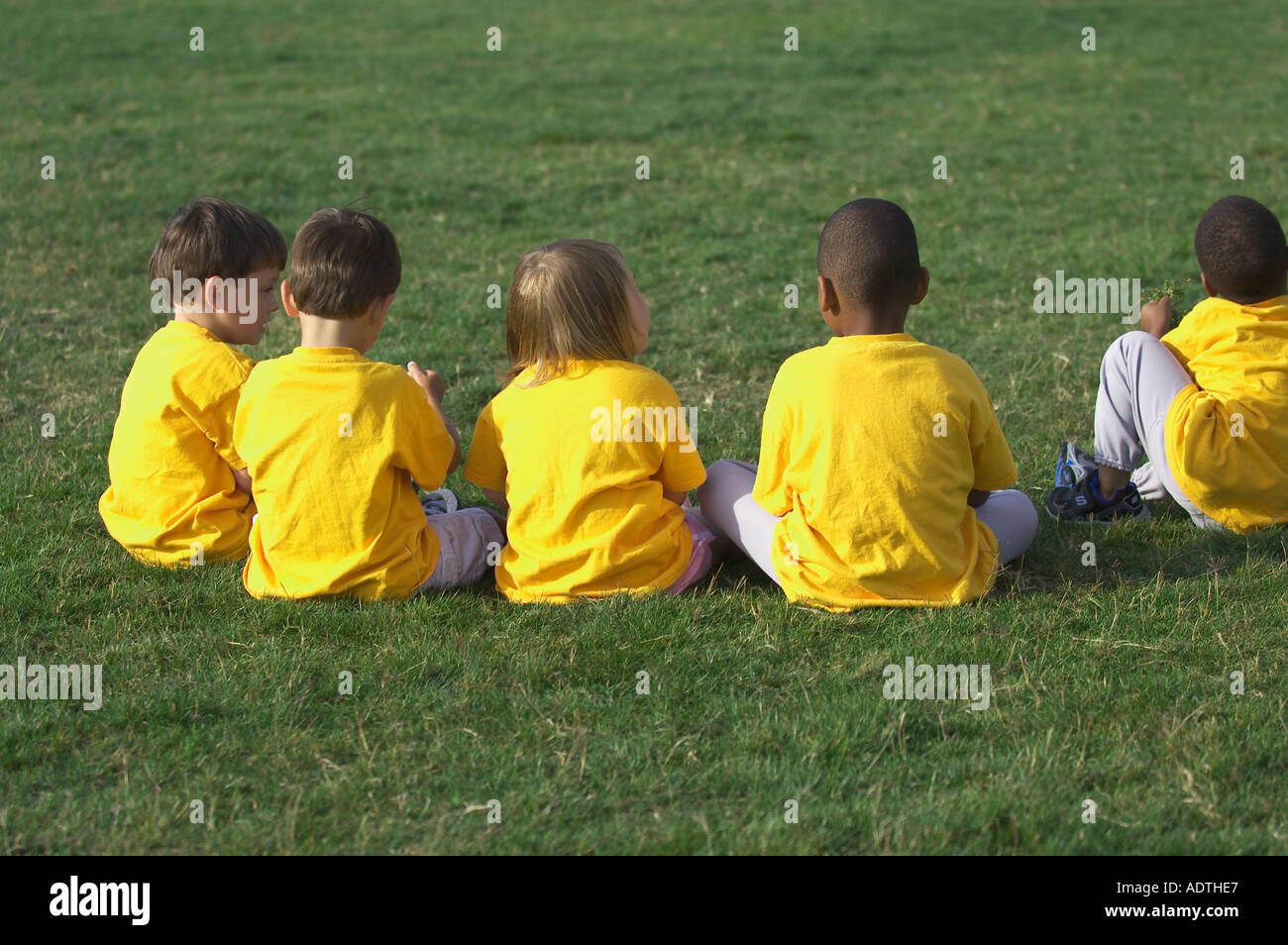 children sitting on grass Stock Photo - Alamy