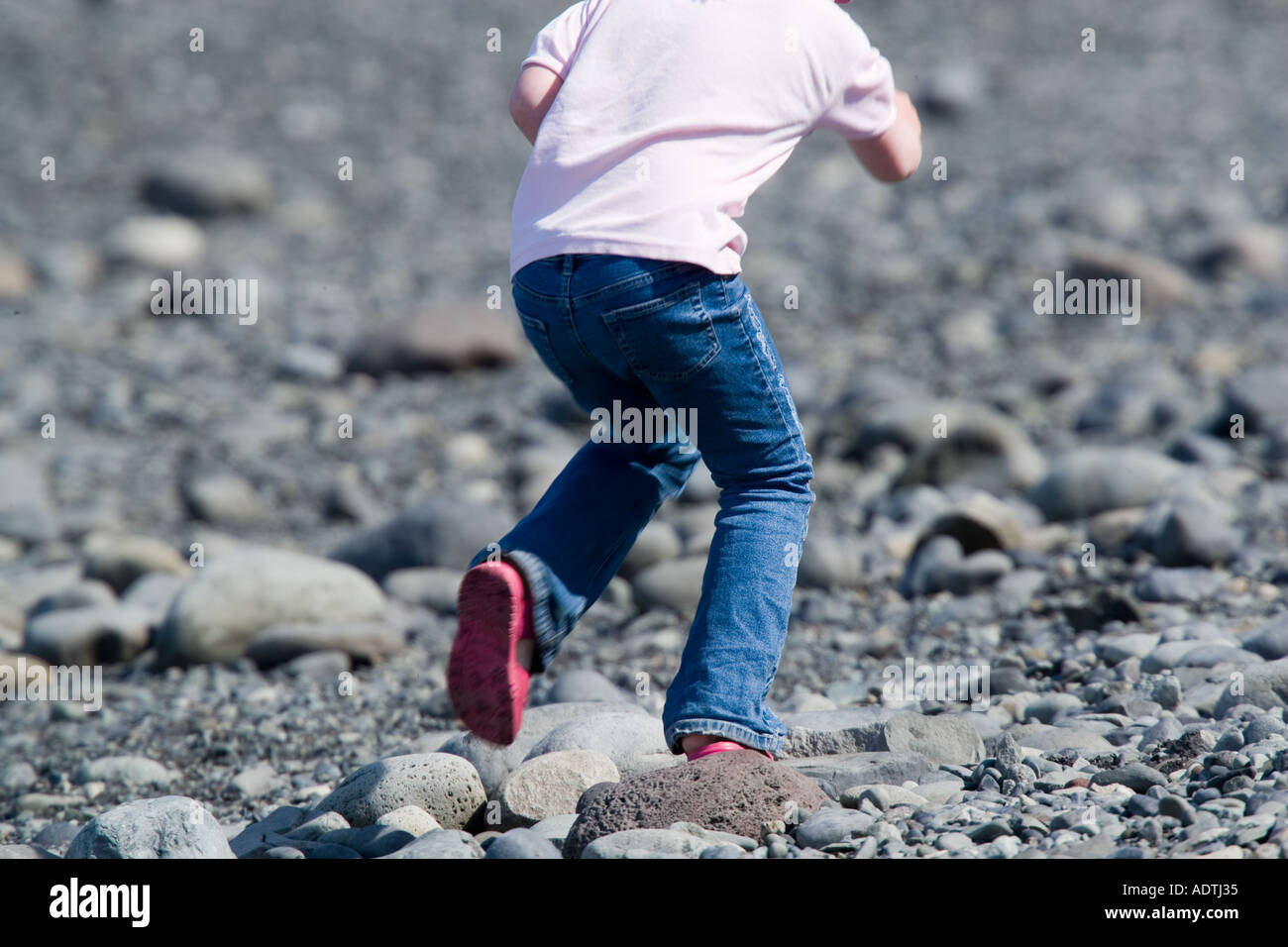 girl running on stones Stock Photo - Alamy