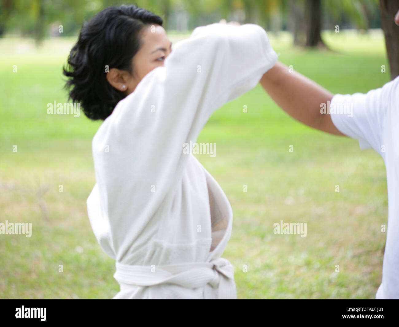 Side profile of a young woman practicing martial arts Stock Photo - Alamy