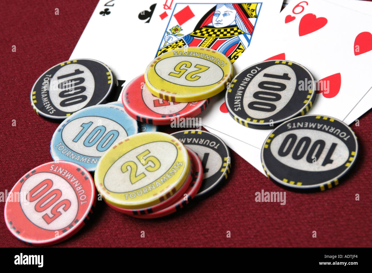 A hand of cards spread out on a red poker table with four piles of ...