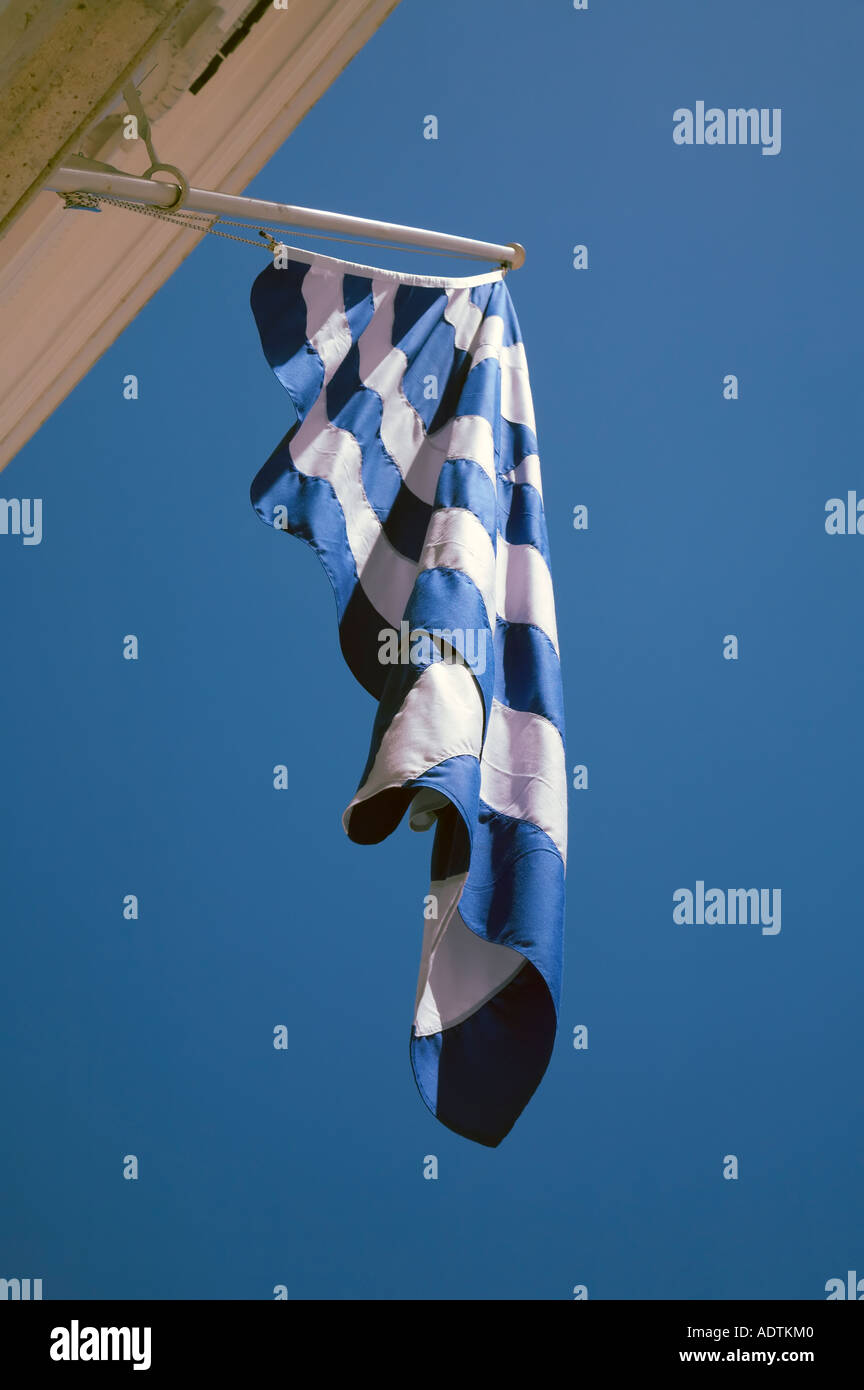 Greek flag hanging ina Corfiot town square Stock Photo - Alamy