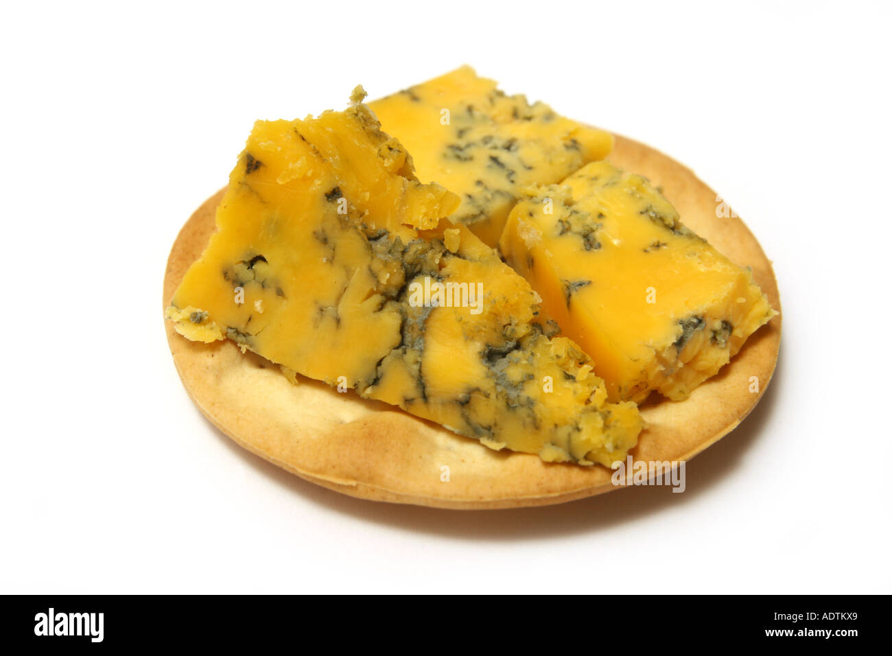 Red Stilton on a cheese biscuit isolated on a white studio background ...