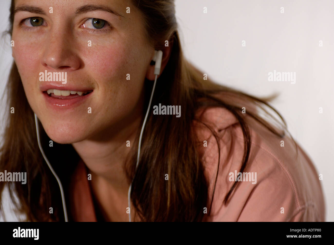 Woman listening to ipod while posing for a portrait Stock Photo - Alamy