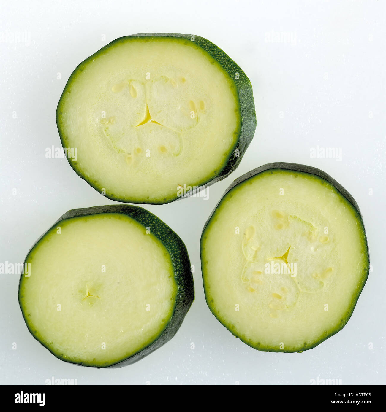 Three slices of courgette Stock Photo - Alamy