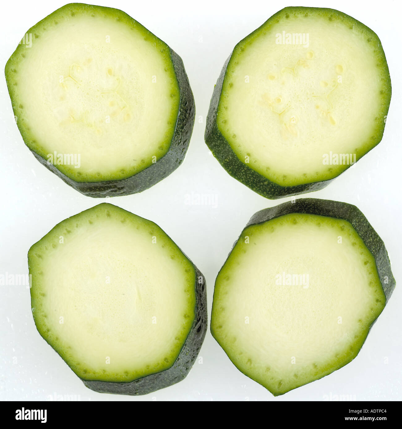 Four slices of courgette Stock Photo - Alamy