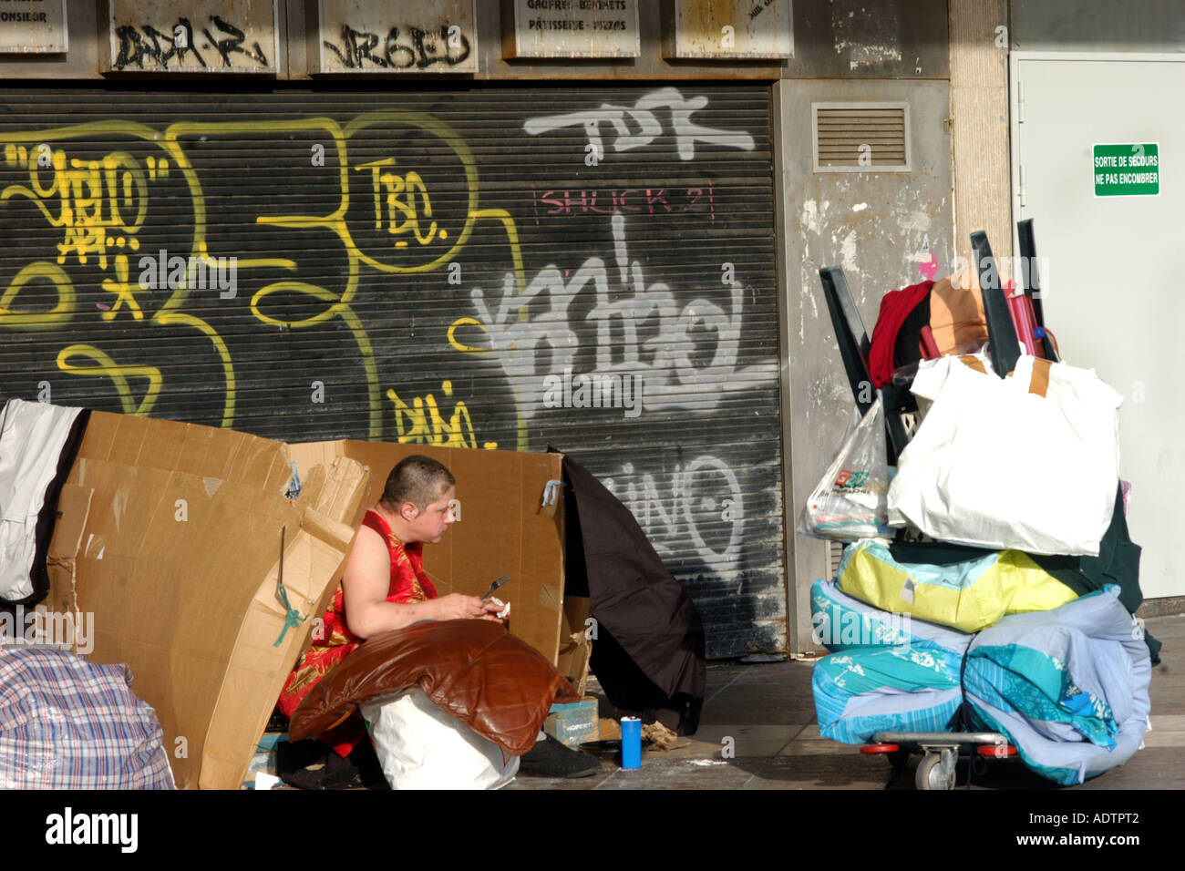 A homeless women and her belongings lives in a cardboard house on a ...