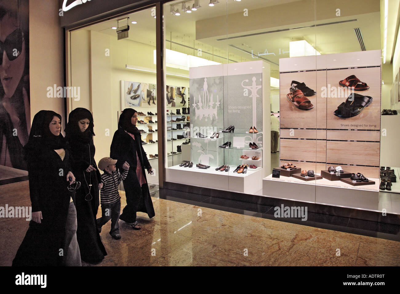 muslim women walking by a modern shoe shop Stock Photo - Alamy