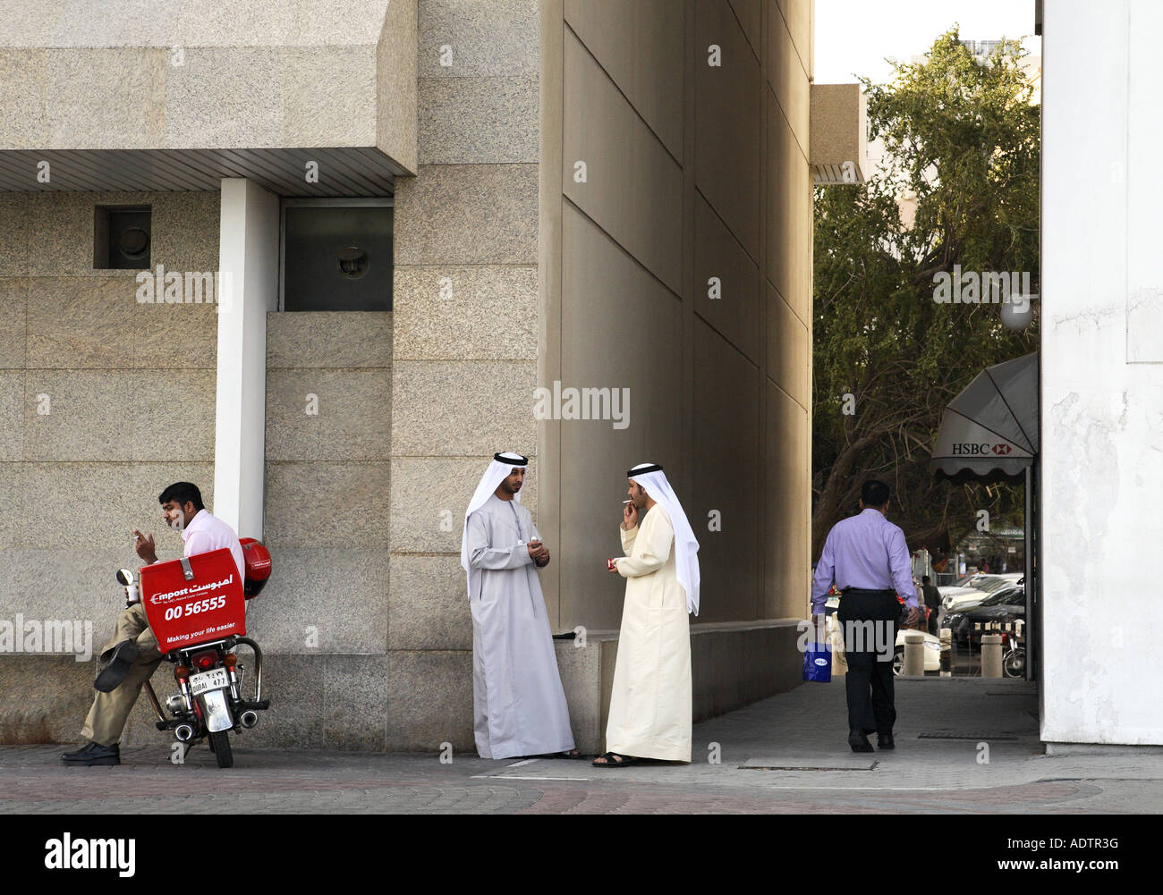 two arab men in traditional costume conversing in the street, Dubai ...