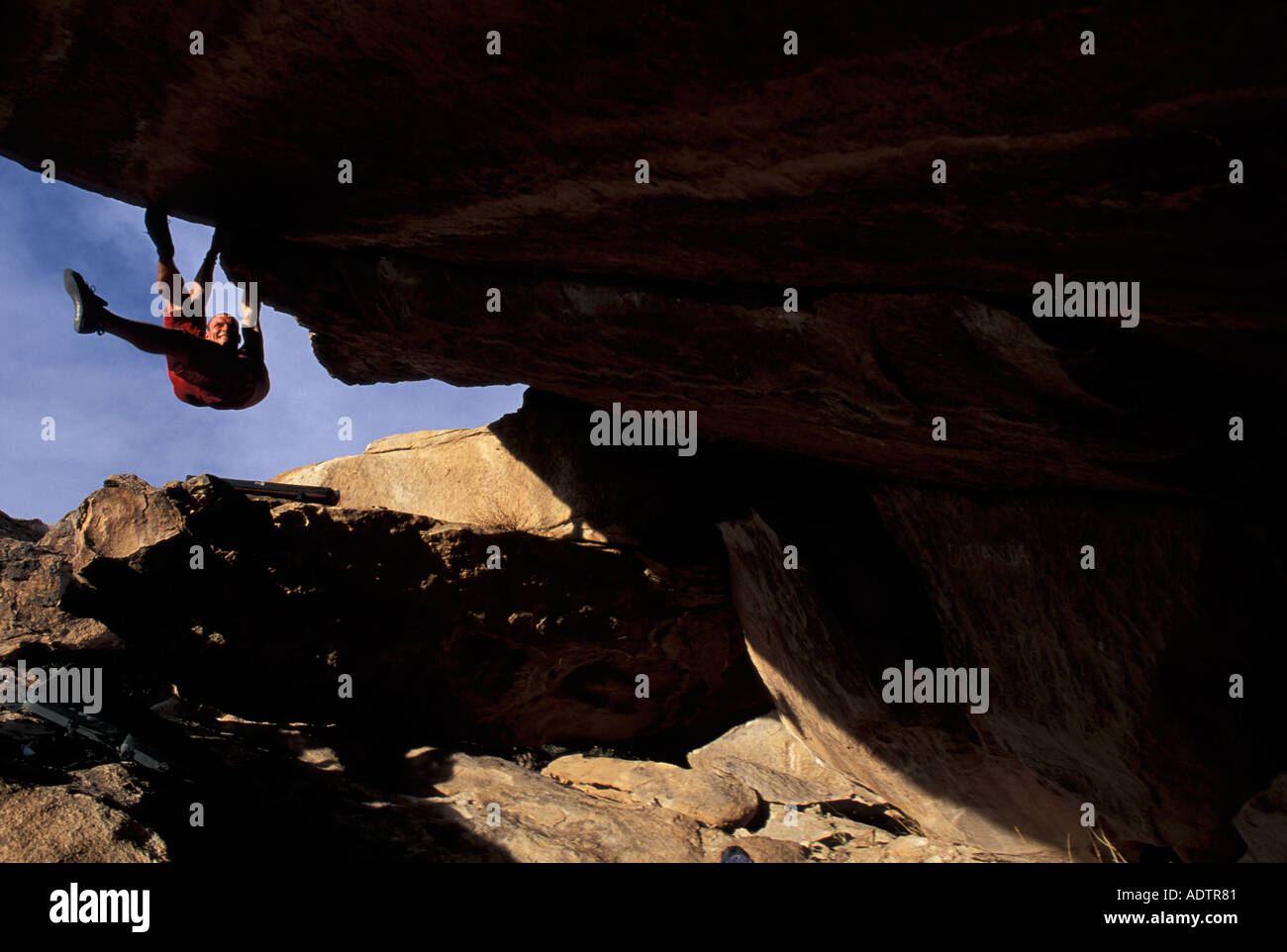 Male rock climber climbing on a steep boulder Stock Photo - Alamy