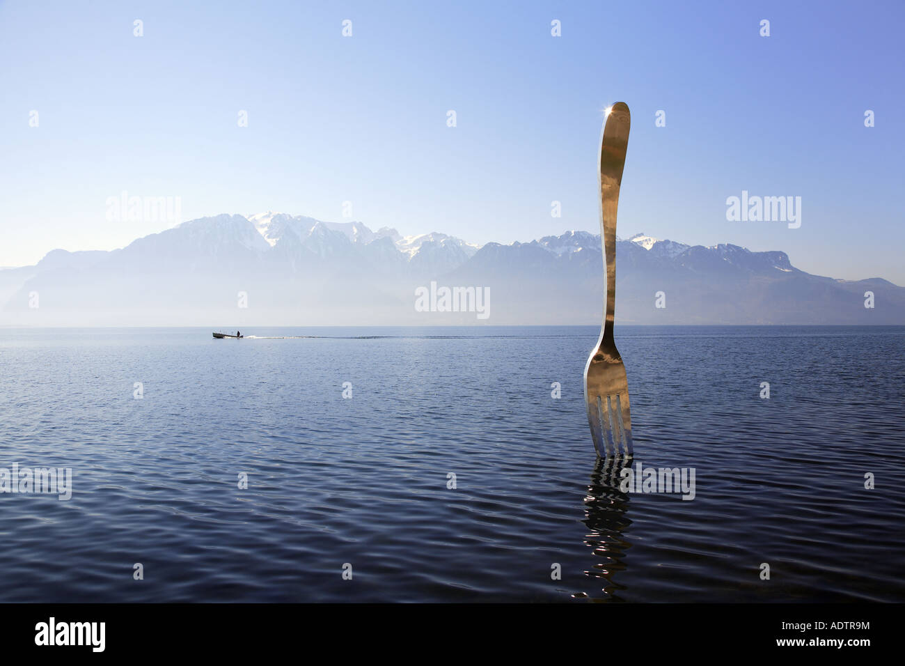 sculpture of a giant fork stuck in water - Switzerland Stock Photo - Alamy